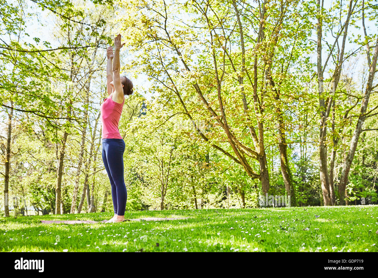 Side view of woman arms raised stretching Stock Photo - Alamy