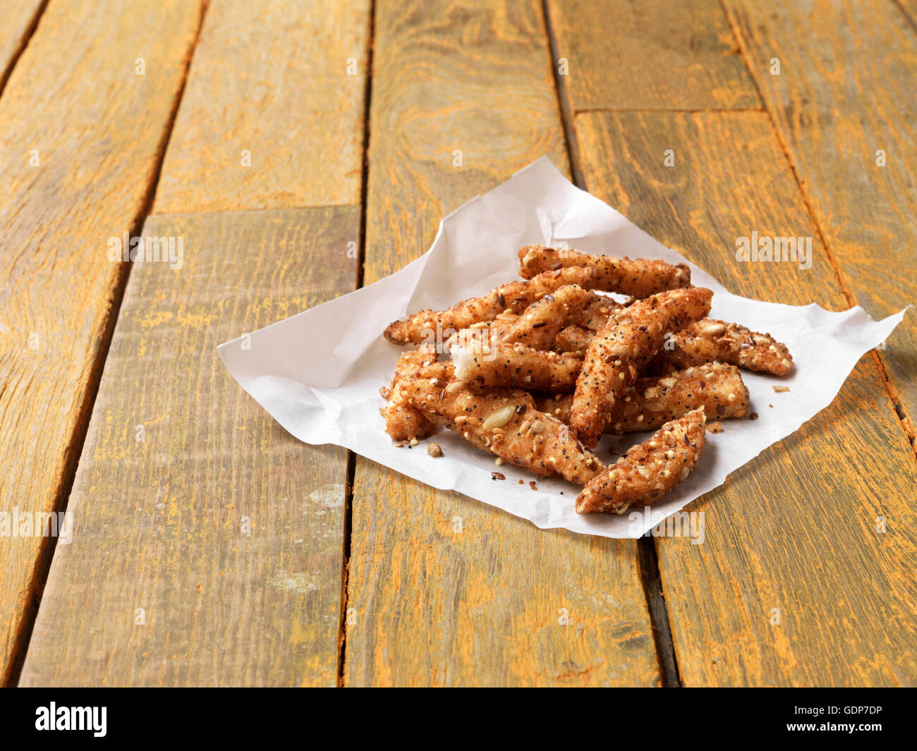 Food, fish, super seeded lightly dusted plaice goujons, painted yellow ...