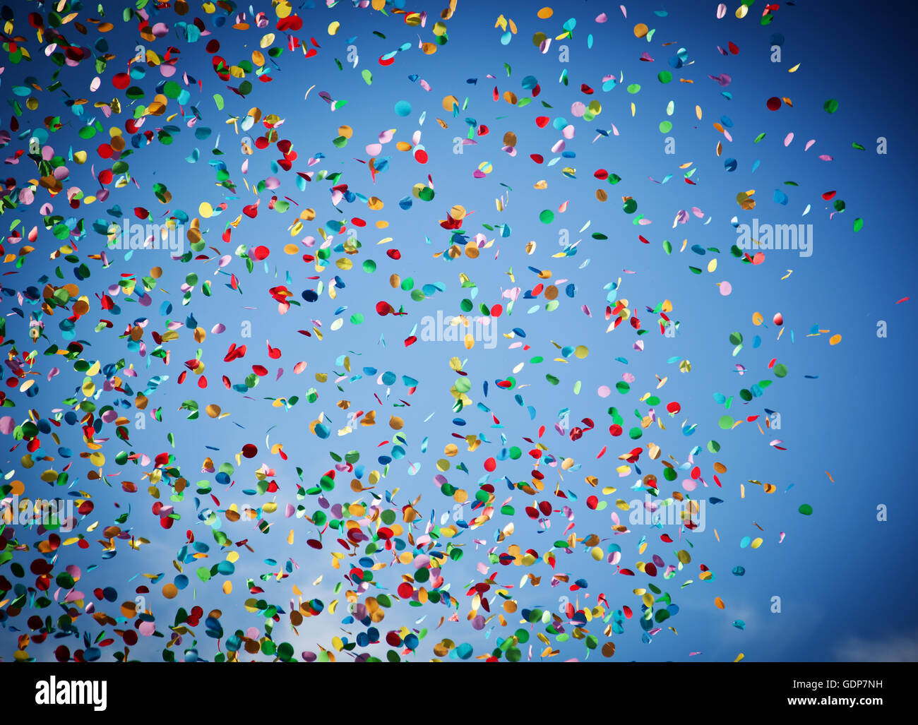falling confetti in the city festival on blue sky background Stock ...