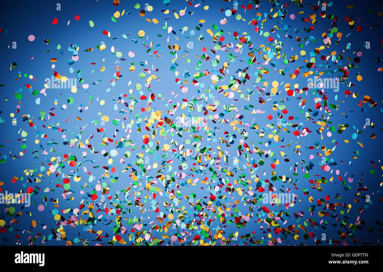falling confetti in the city festival on blue sky background Stock ...