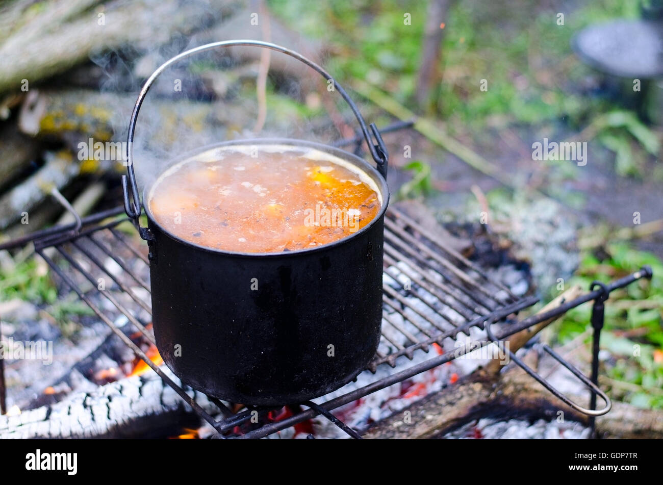 The cooking of soup on the fire on the camping Stock Photo - Alamy