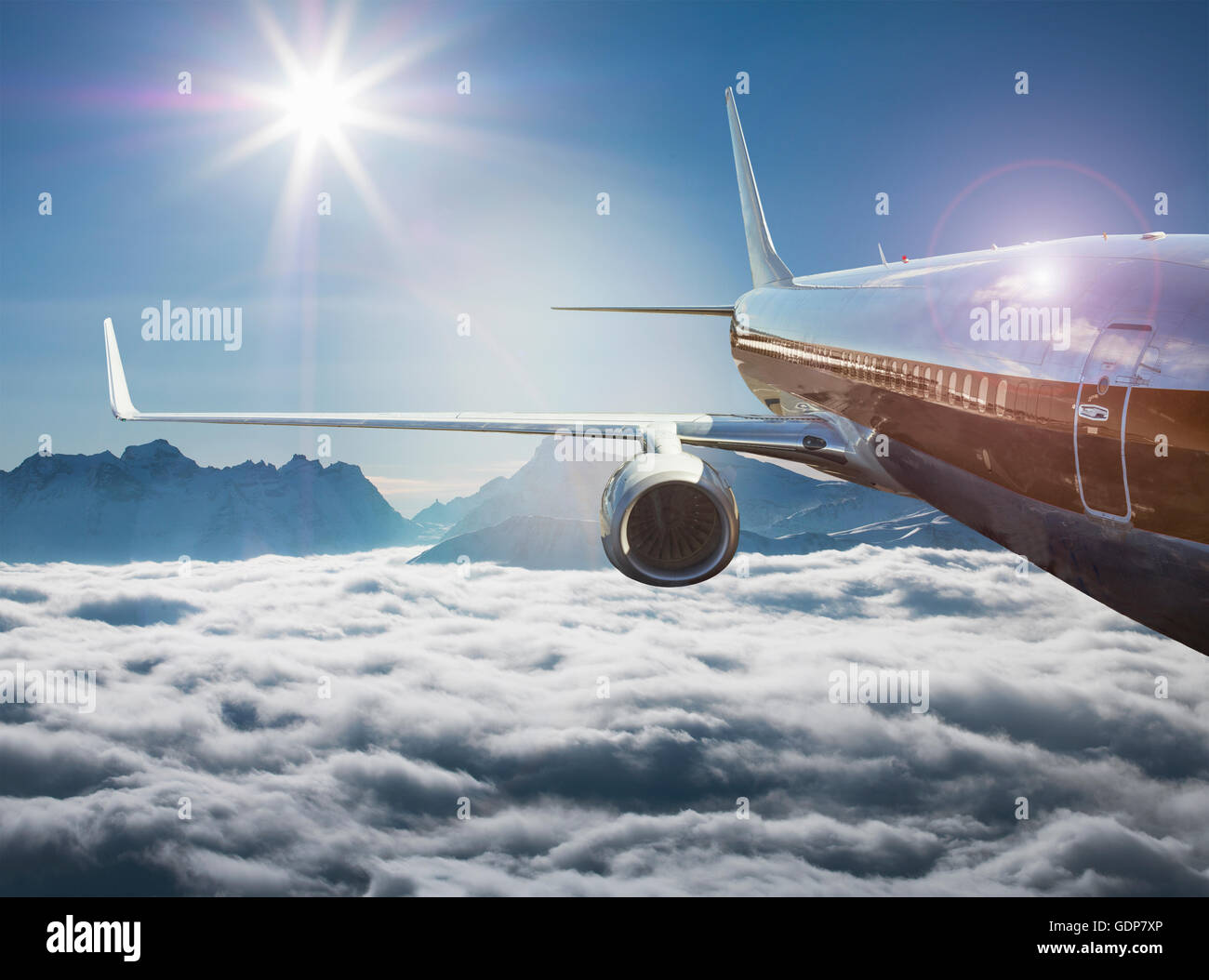 Commercial jet flying over a sea of fog in the Alps, Canton Wallis ...