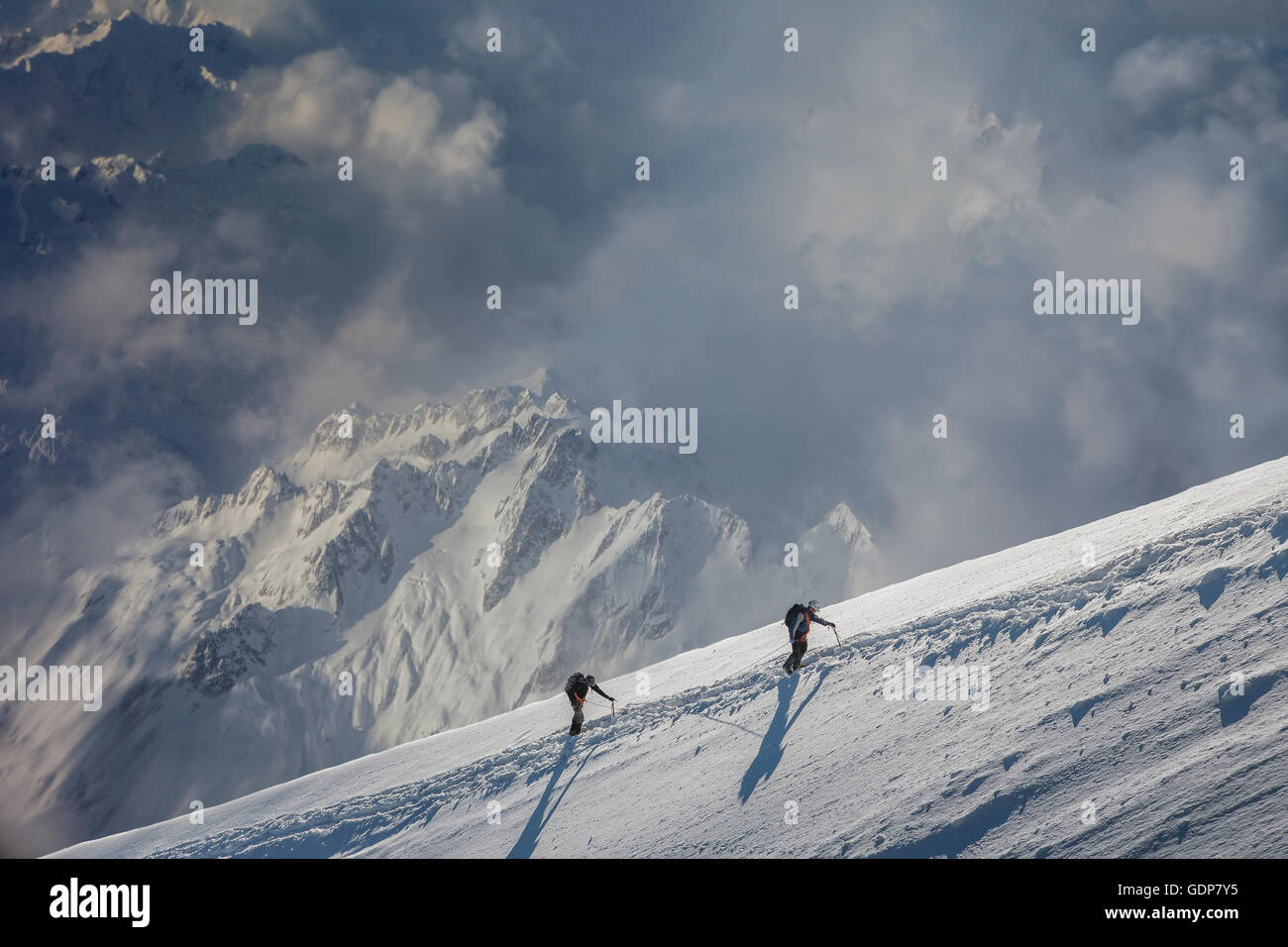 Two climbers ascending a snowy slope, Alps, Canton Wallis, Switzerland ...