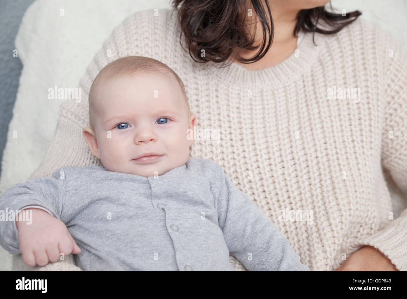Mother sitting with baby boy, mid section Stock Photo - Alamy