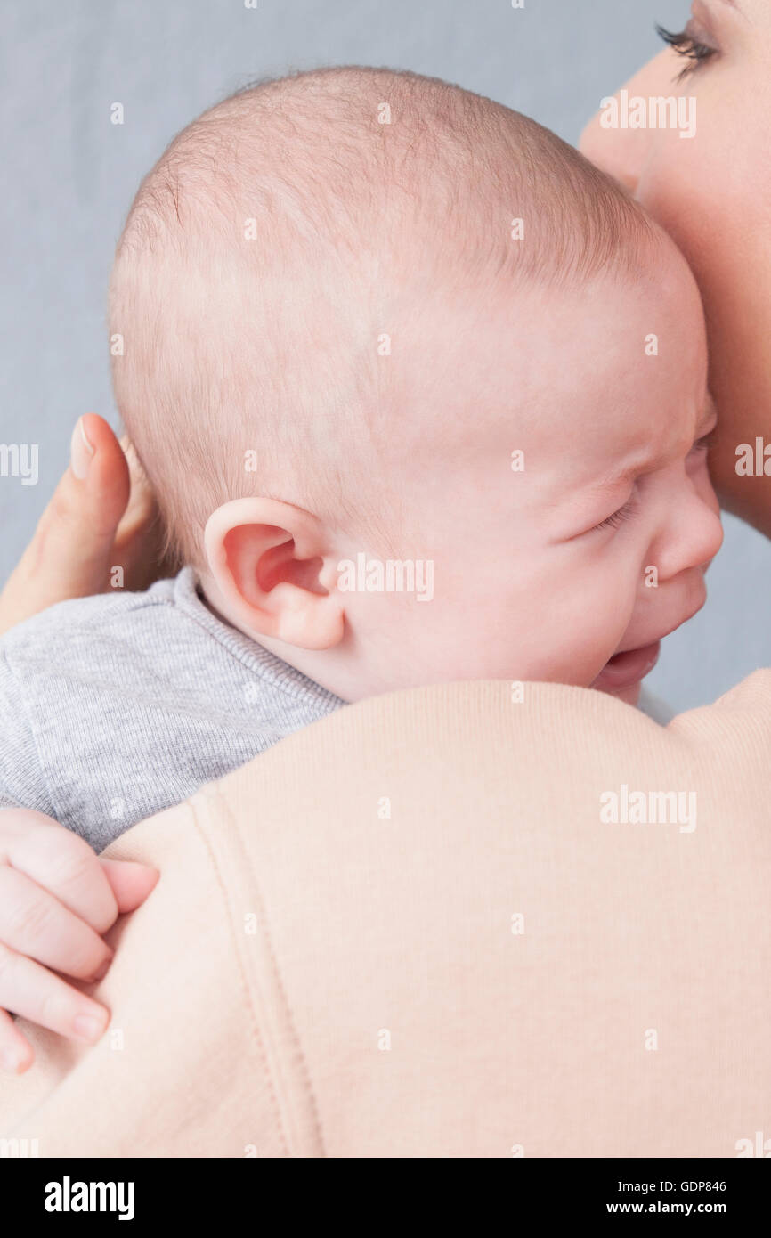 Mother comforting baby boy, close-up Stock Photo - Alamy