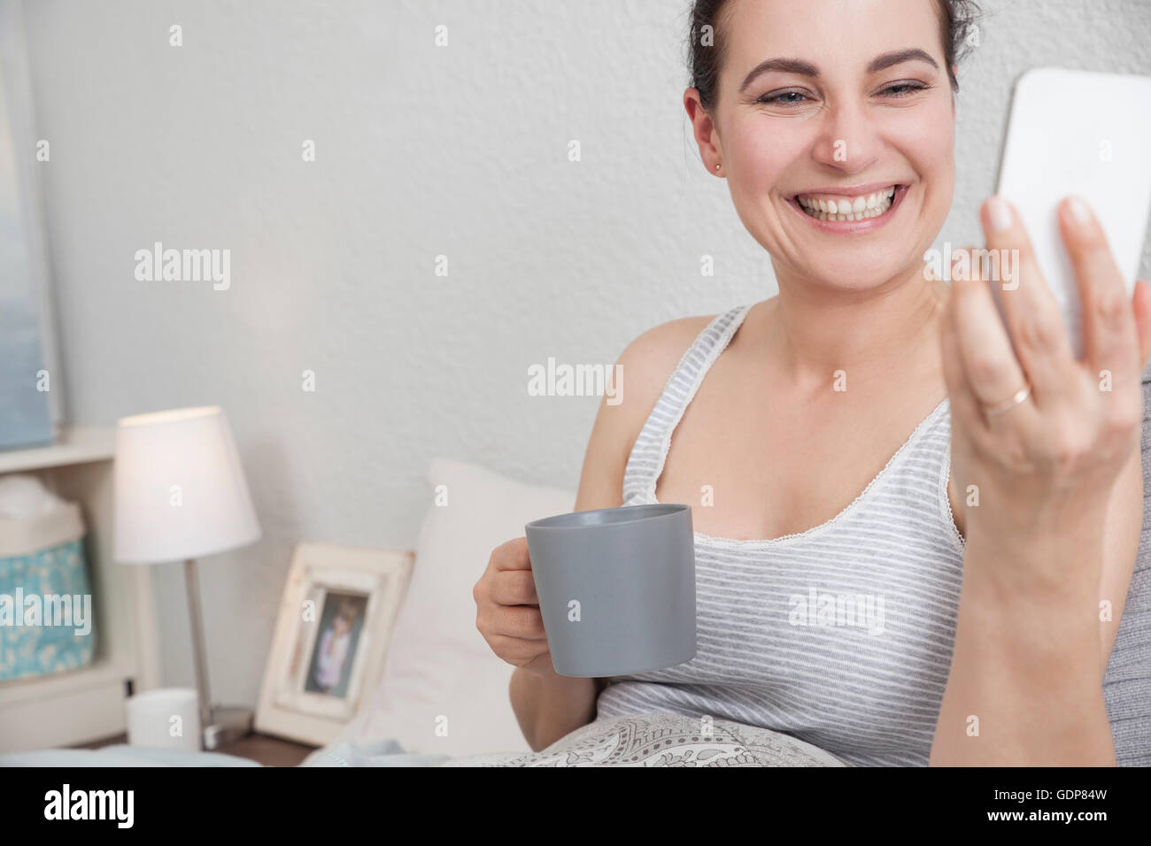 Woman taking self portrait with smartphone Stock Photo - Alamy