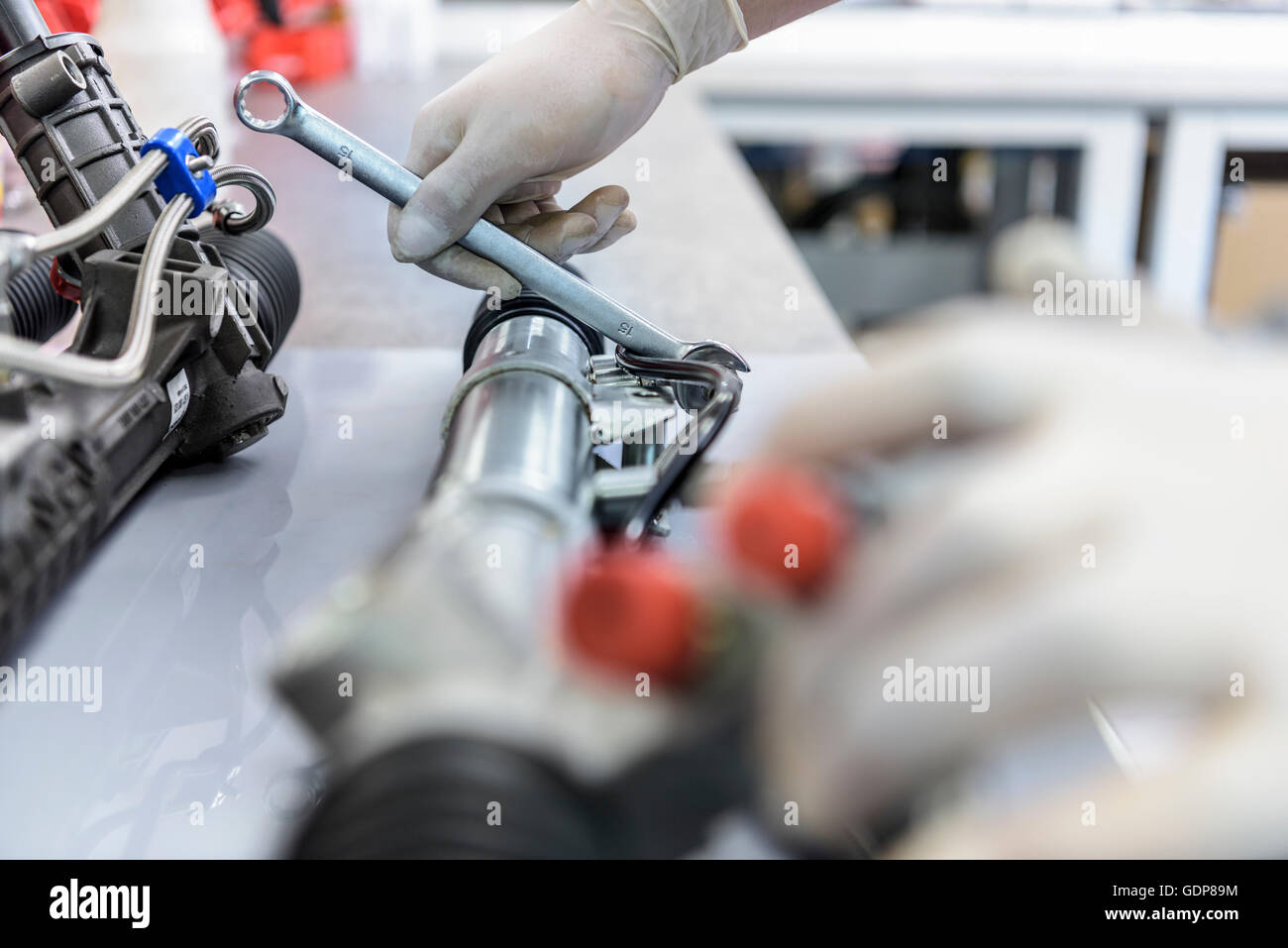 Engineer working on part in racing car factory, close up Stock Photo ...