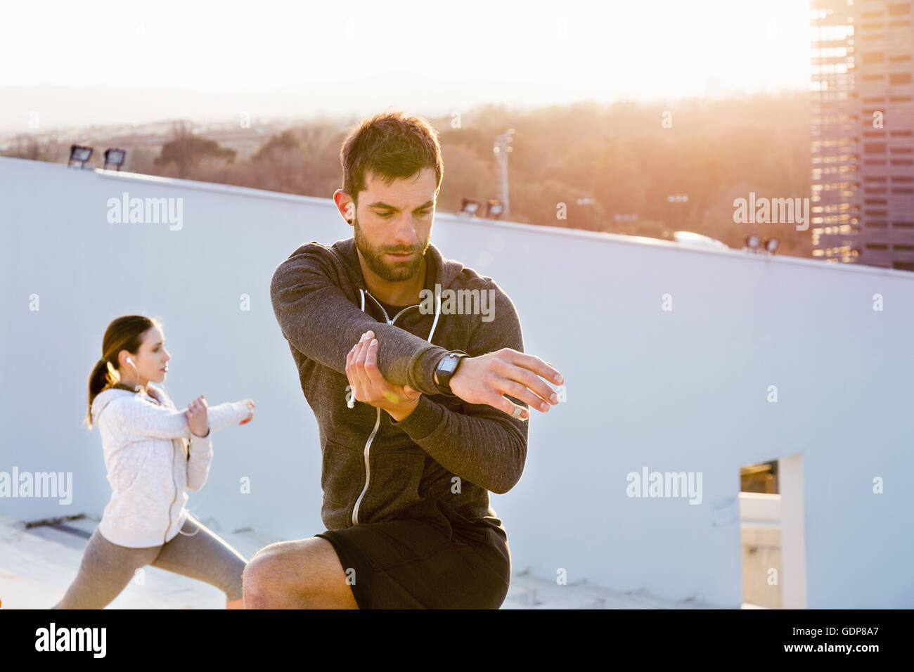 Two friends exercising outdoors, stretching Stock Photo - Alamy