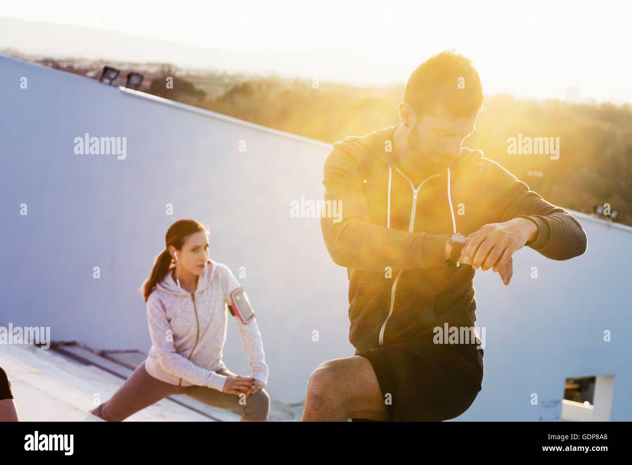 Two friends exercising outdoors, stretching Stock Photo - Alamy