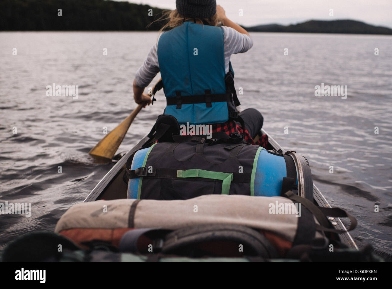 Mid adult woman canoeing on lake, rear view Stock Photo - Alamy