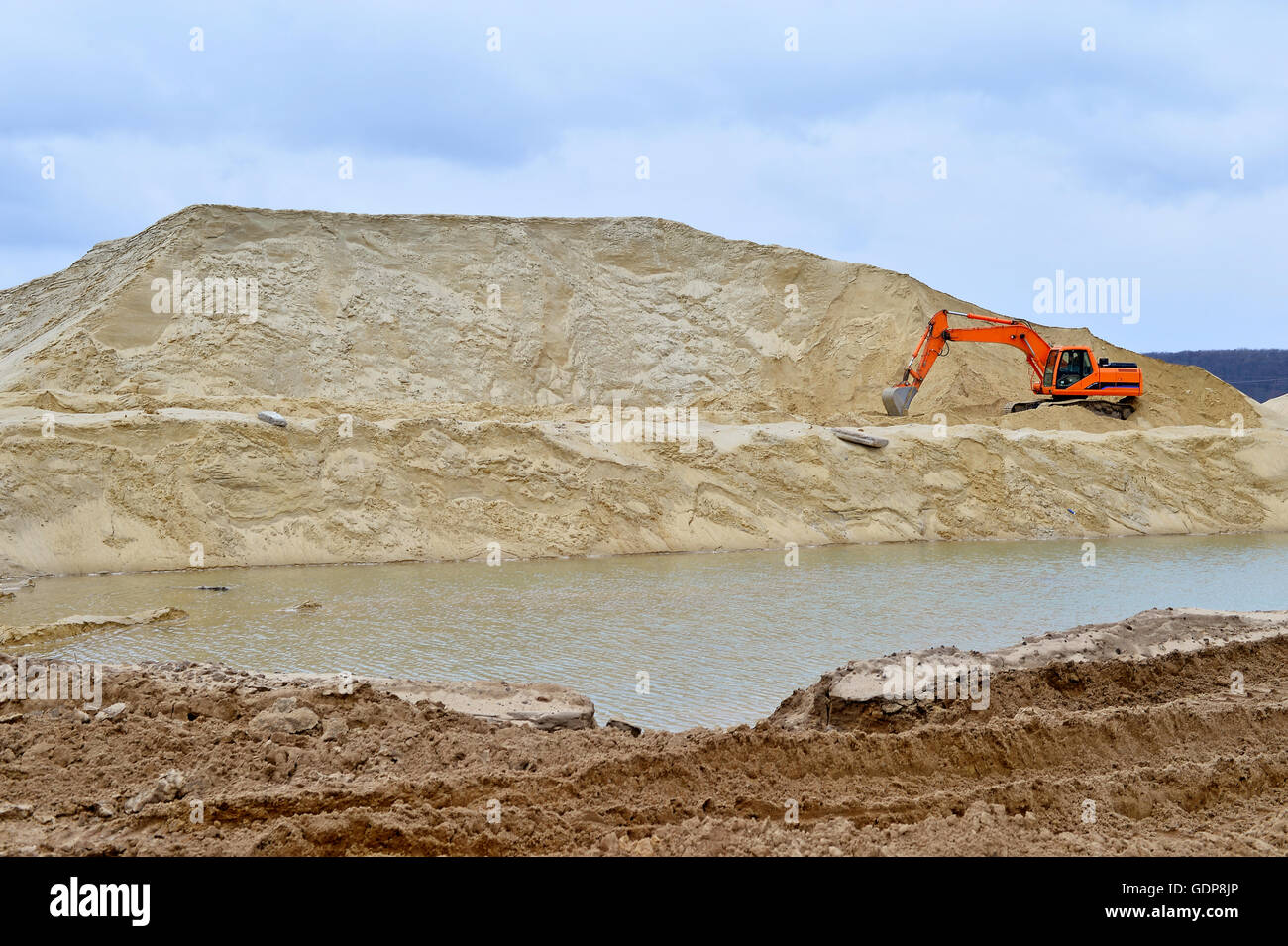 Working digger in a quarry produces sand Stock Photo - Alamy