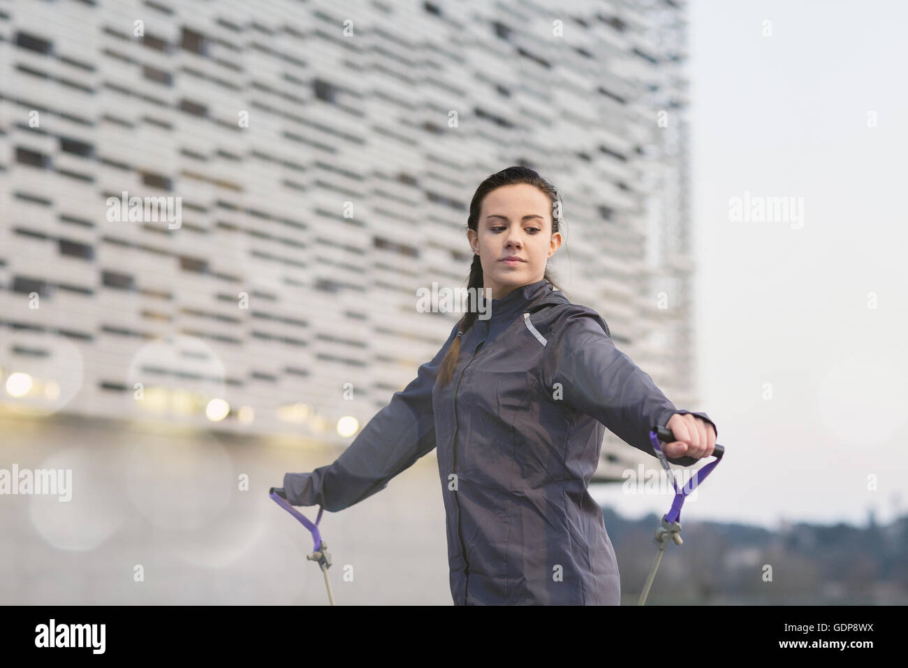 Young woman exercising outdoors, using stretching rope Stock Photo - Alamy