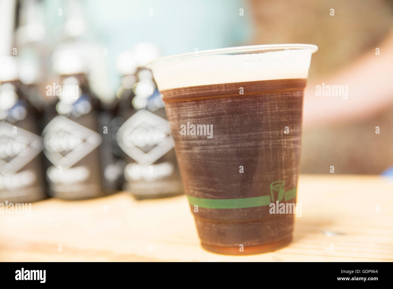 Cup and bottles of cold brew coffee on cooperative food market stall ...