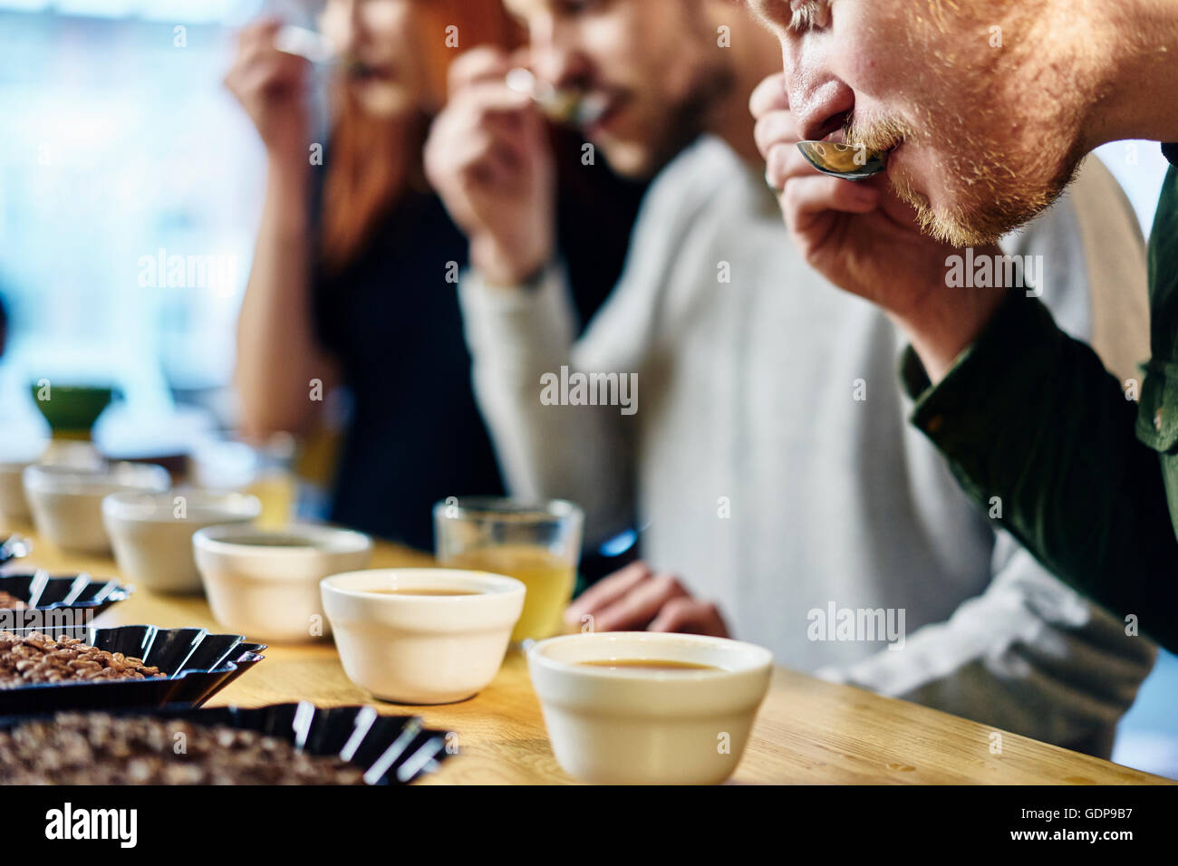 Team tasting bowls of coffee at coffee shop tasting Stock Photo - Alamy