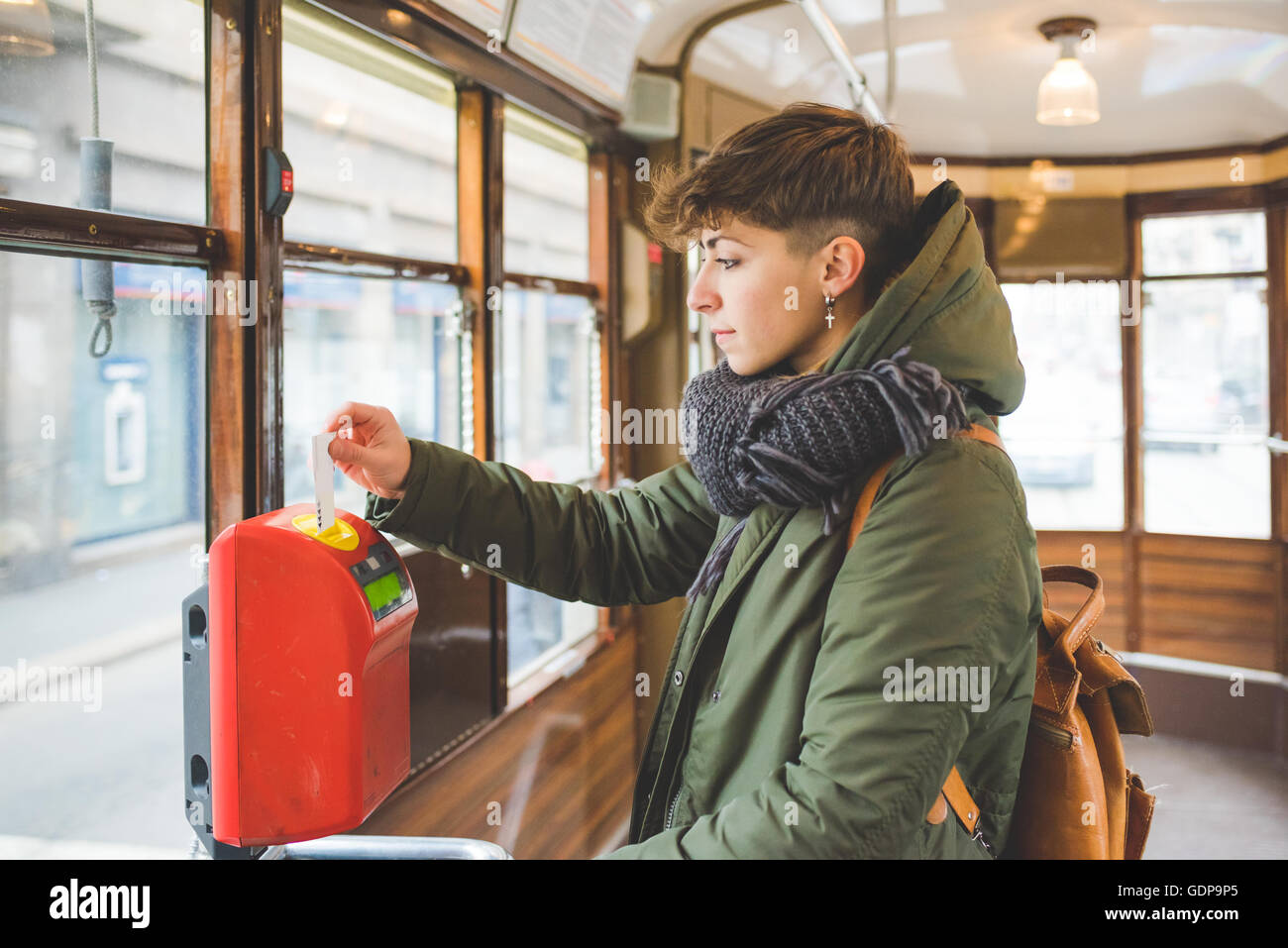 Young woman taking ticket on cable car Stock Photo - Alamy