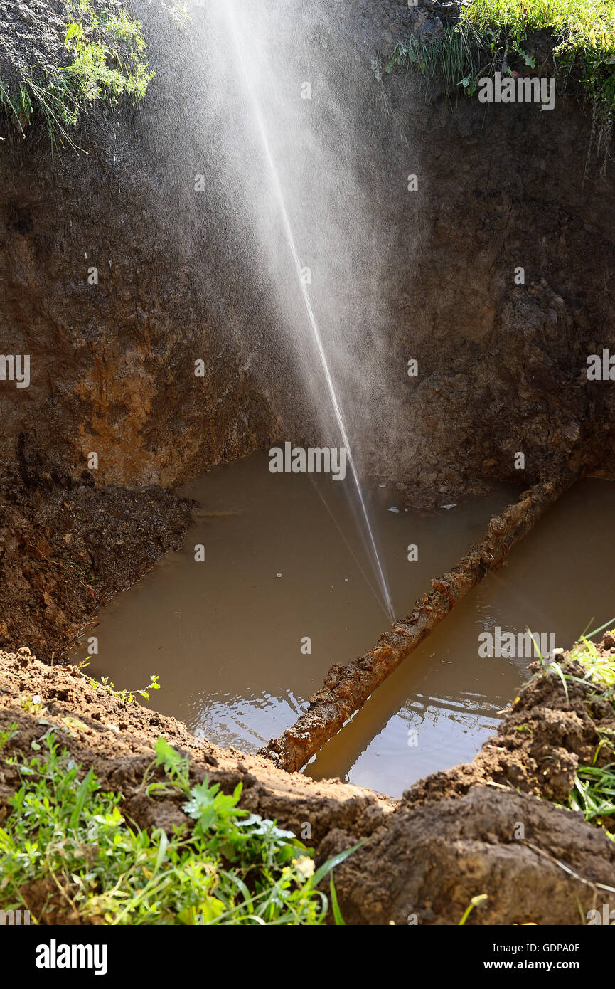 The water jet in the form of leakage in the damaged metal pipe at the ...