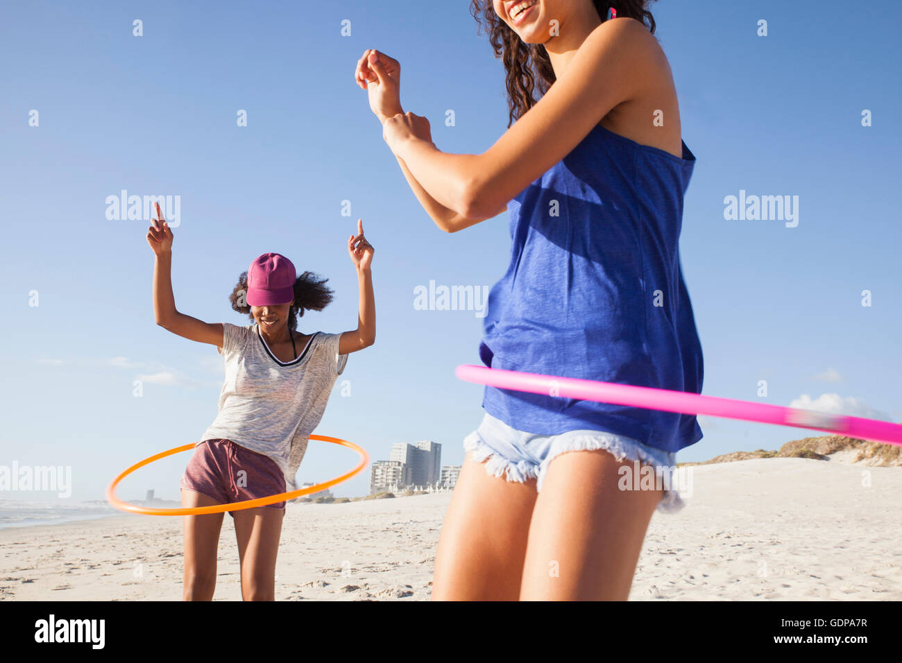 Women on beach using hula hoops Stock Photo - Alamy
