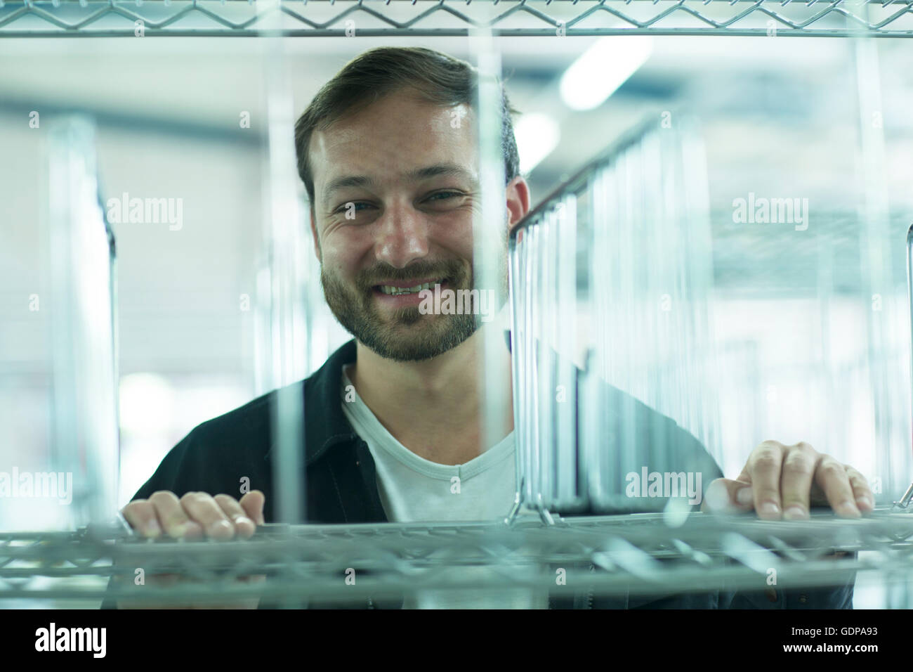 Man pushing roll cage smiling Stock Photo - Alamy
