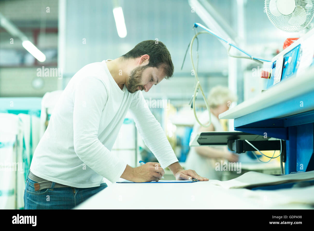 Man working in laundrette hi-res stock photography and images - Alamy