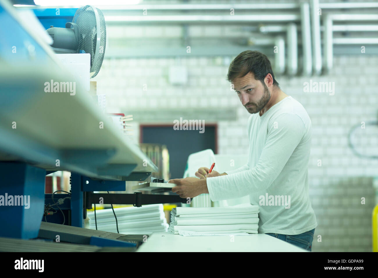 Man working in laundrette hi-res stock photography and images - Alamy