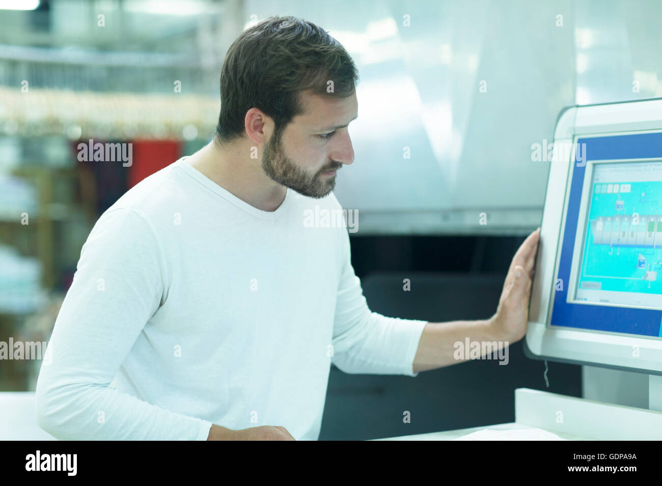 Man looking at computer monitor Stock Photo - Alamy