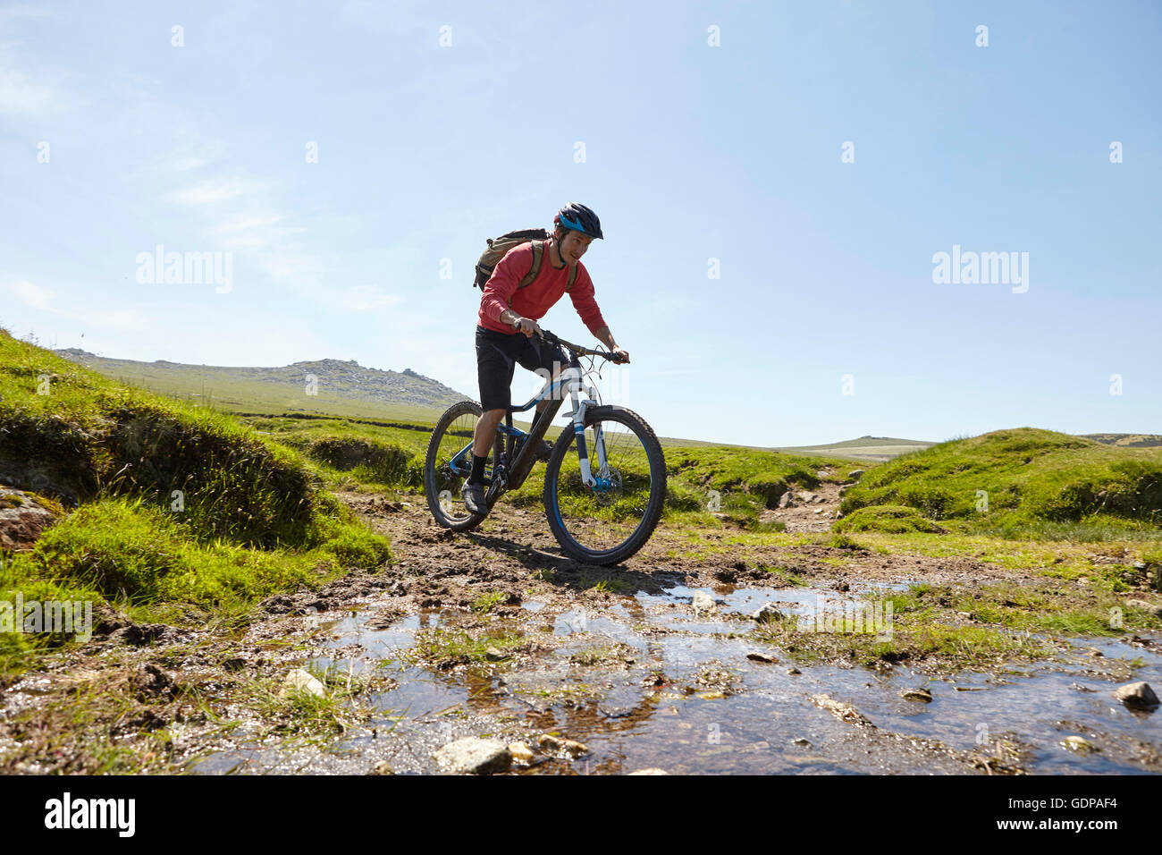 Cyclists cycling through water Stock Photo - Alamy