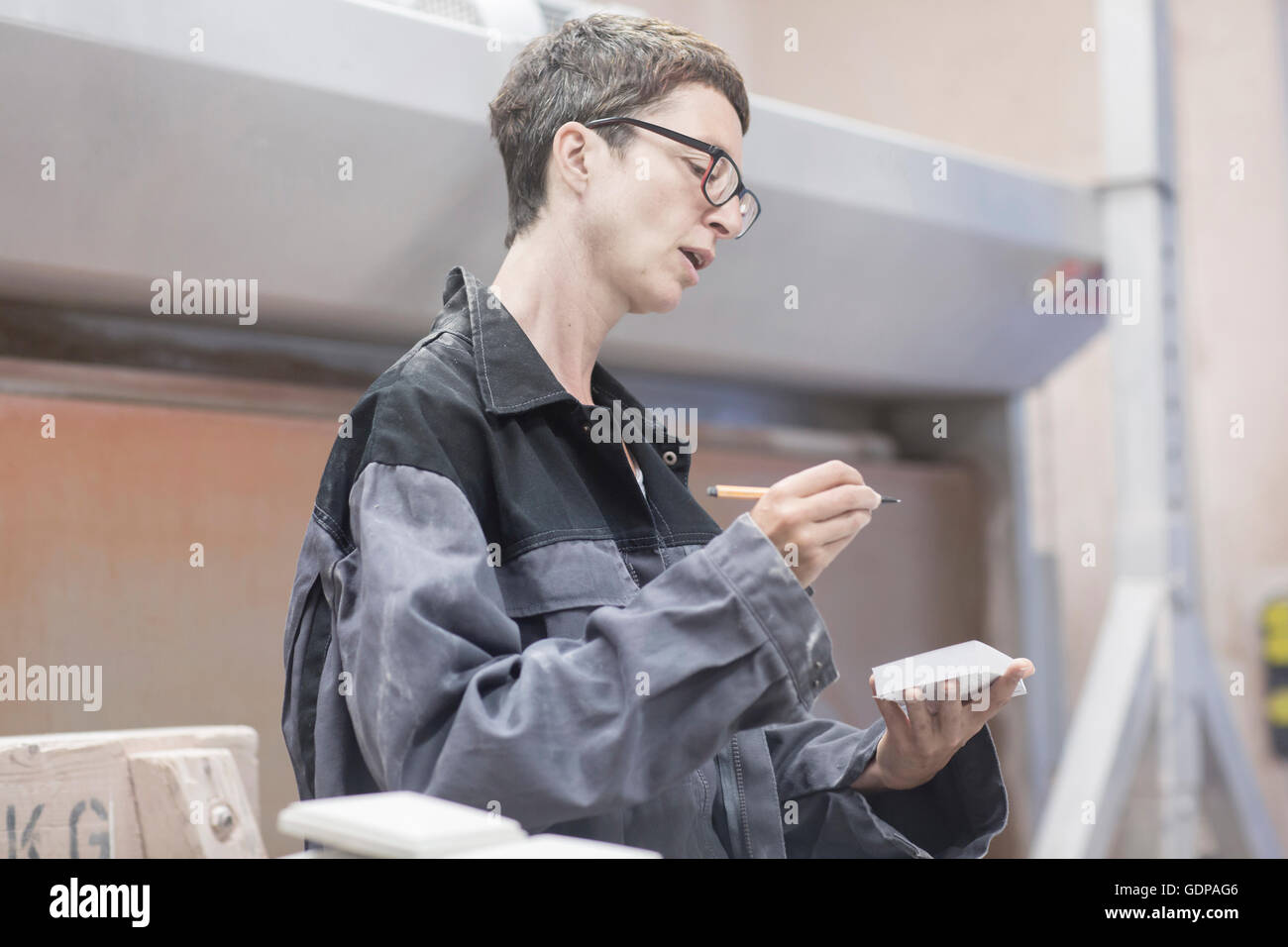 Stonemason writing in notebook Stock Photo - Alamy