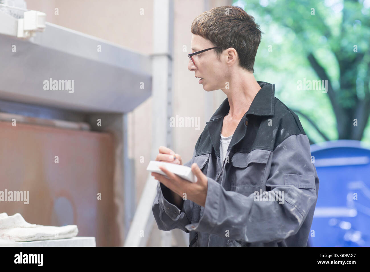 Stonemason writing in notebook Stock Photo - Alamy