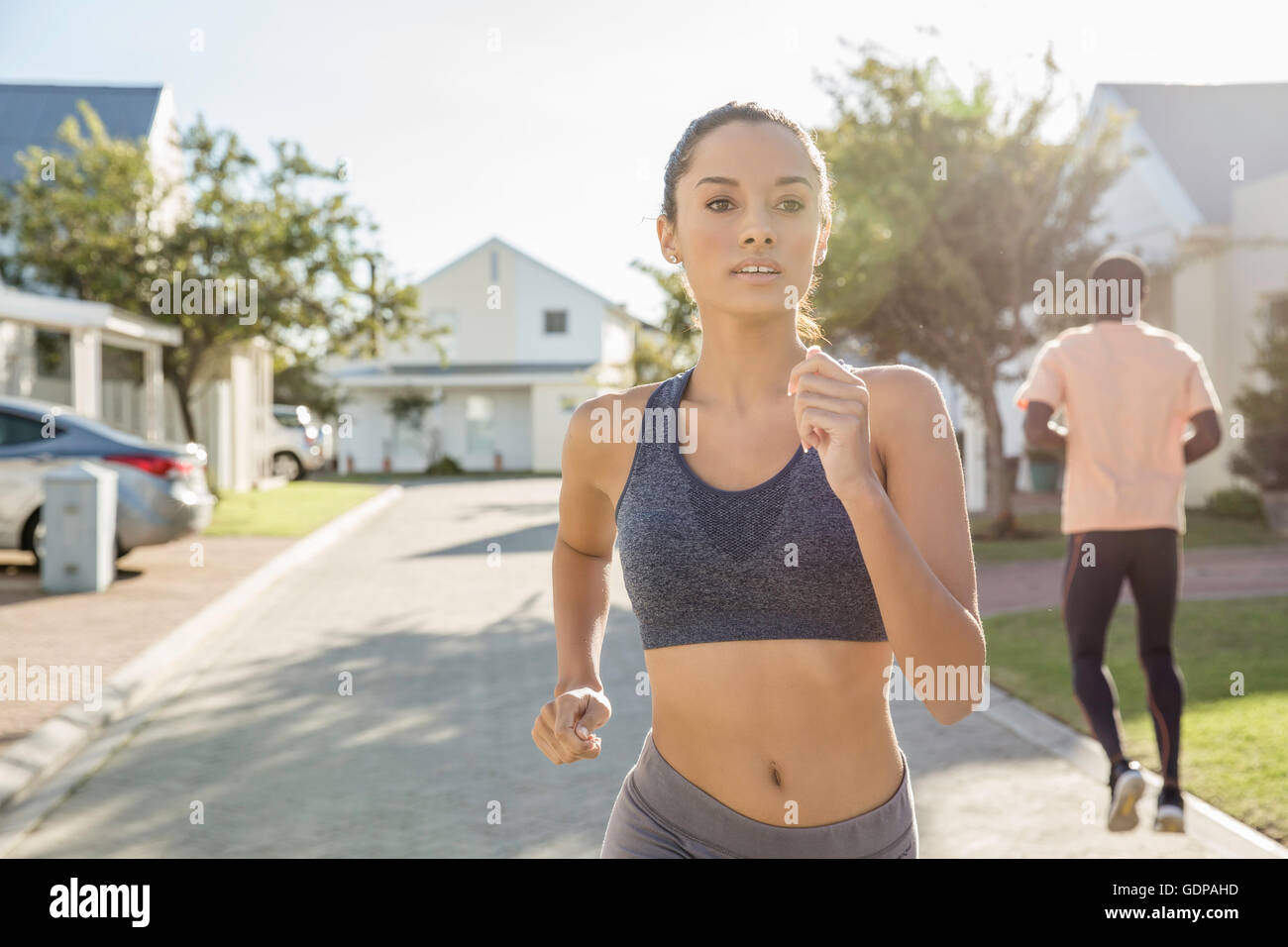 Woman running residential hi-res stock photography and images - Alamy