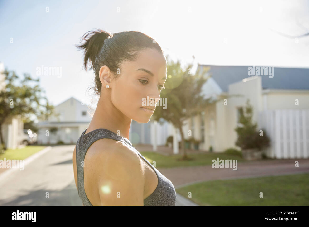 Side view portrait of woman in residential area looking down Stock ...
