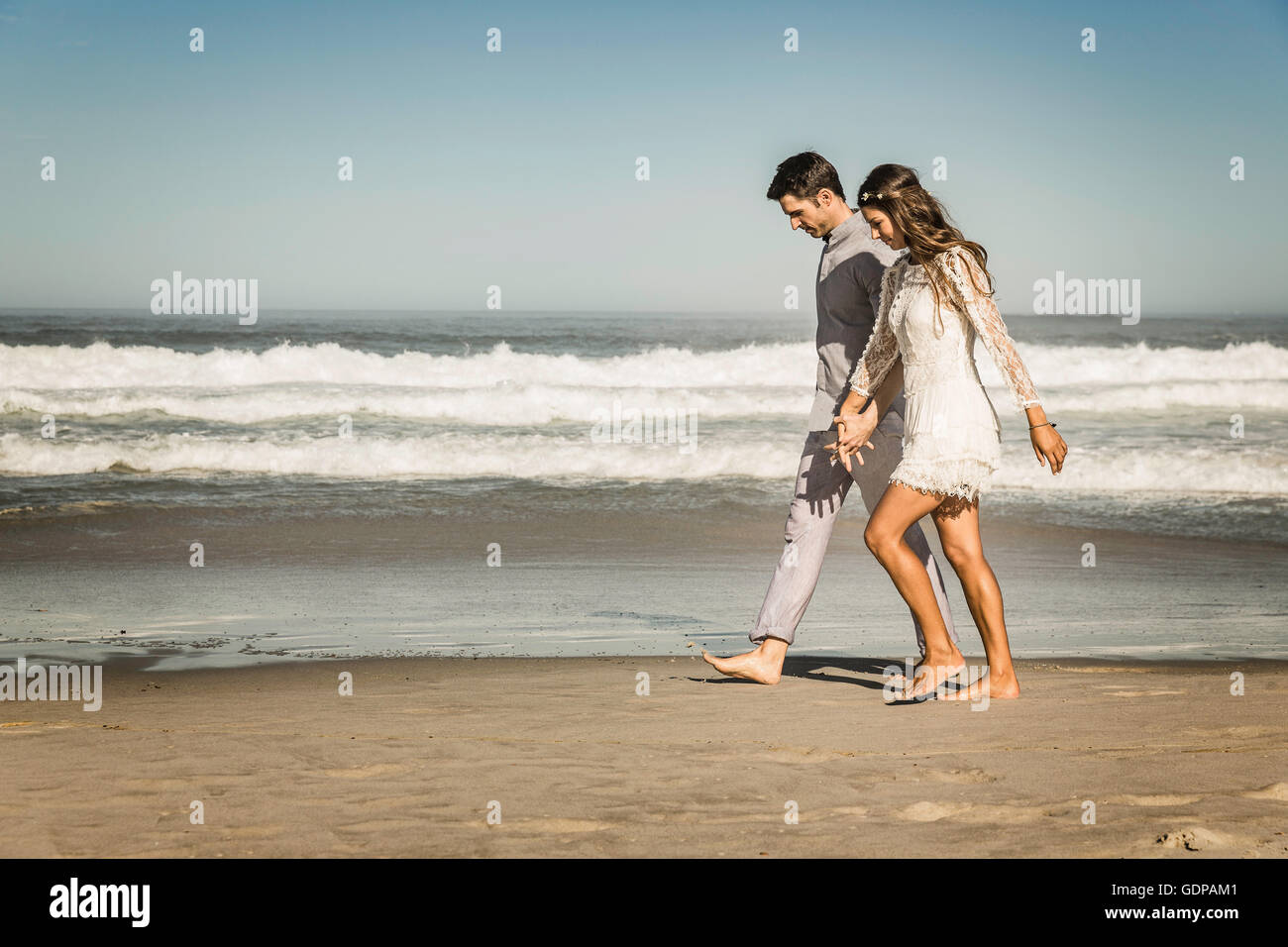Couple holding hand on beach hi-res stock photography and images - Alamy
