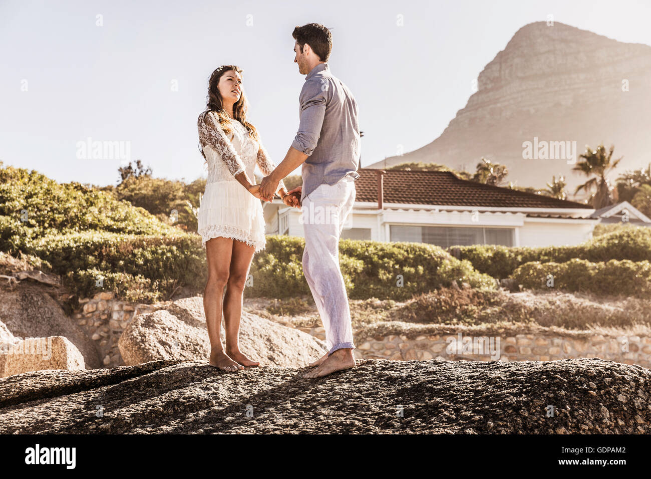 Couple standing hand in hand on beach, Cape Town, South Africa Stock ...
