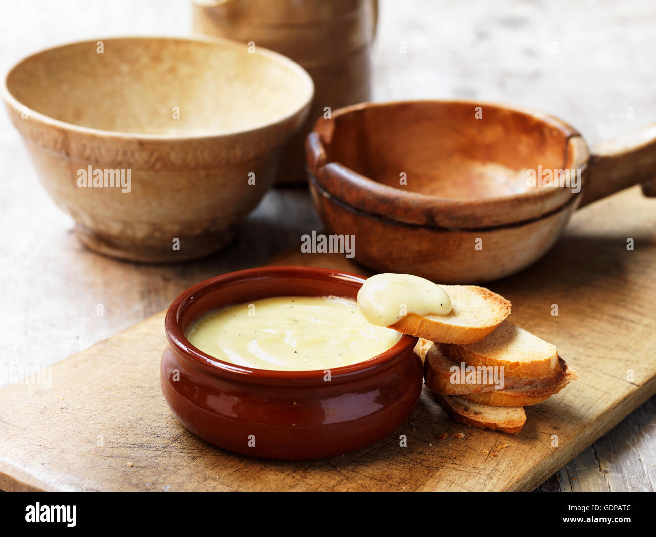 Cheese fondue in terracotta bowl Stock Photo - Alamy