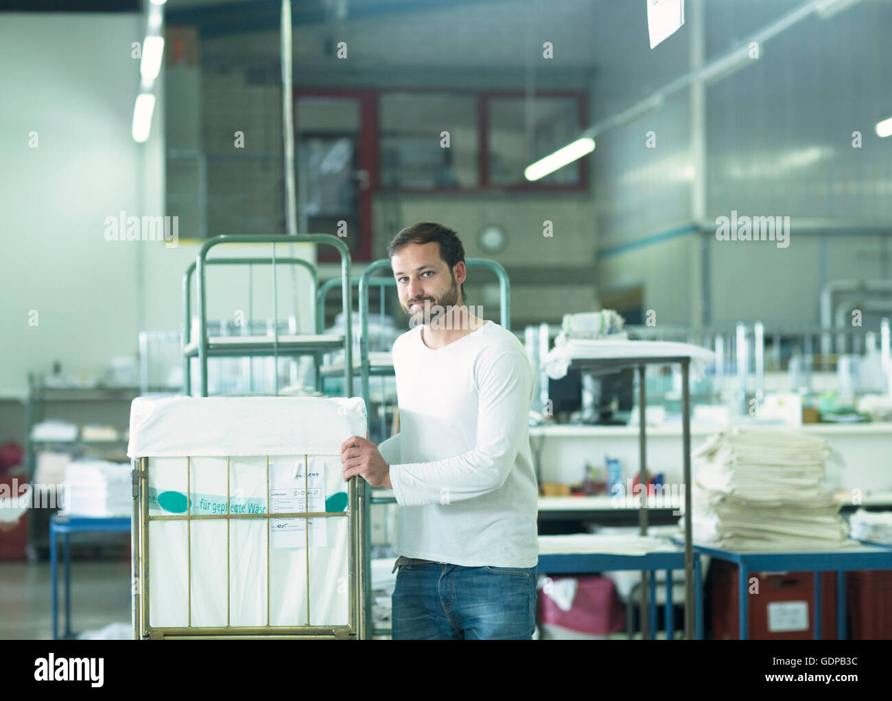 Man working in laundrette hi-res stock photography and images - Alamy