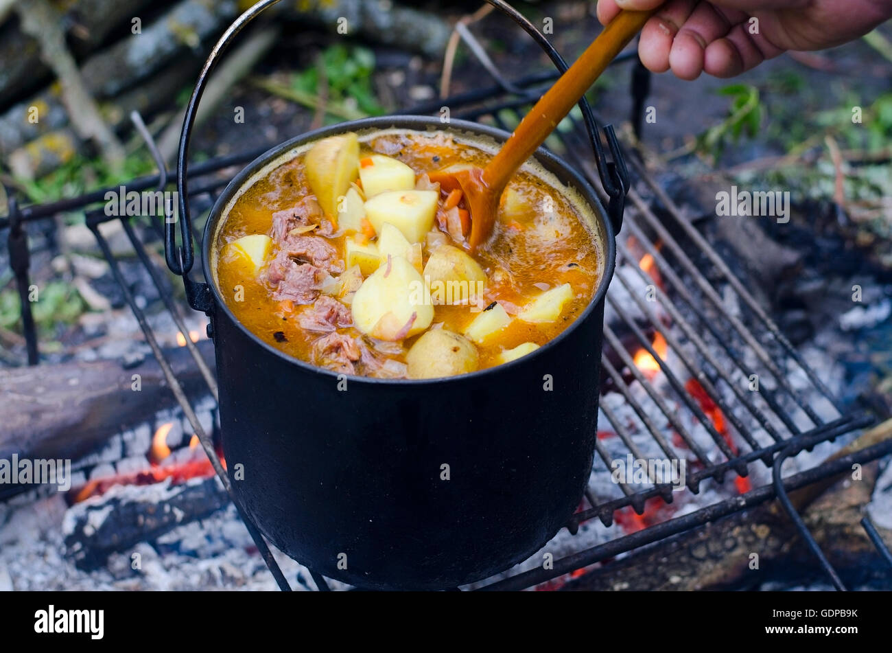 The cooking of soup on the fire on the camping Stock Photo - Alamy