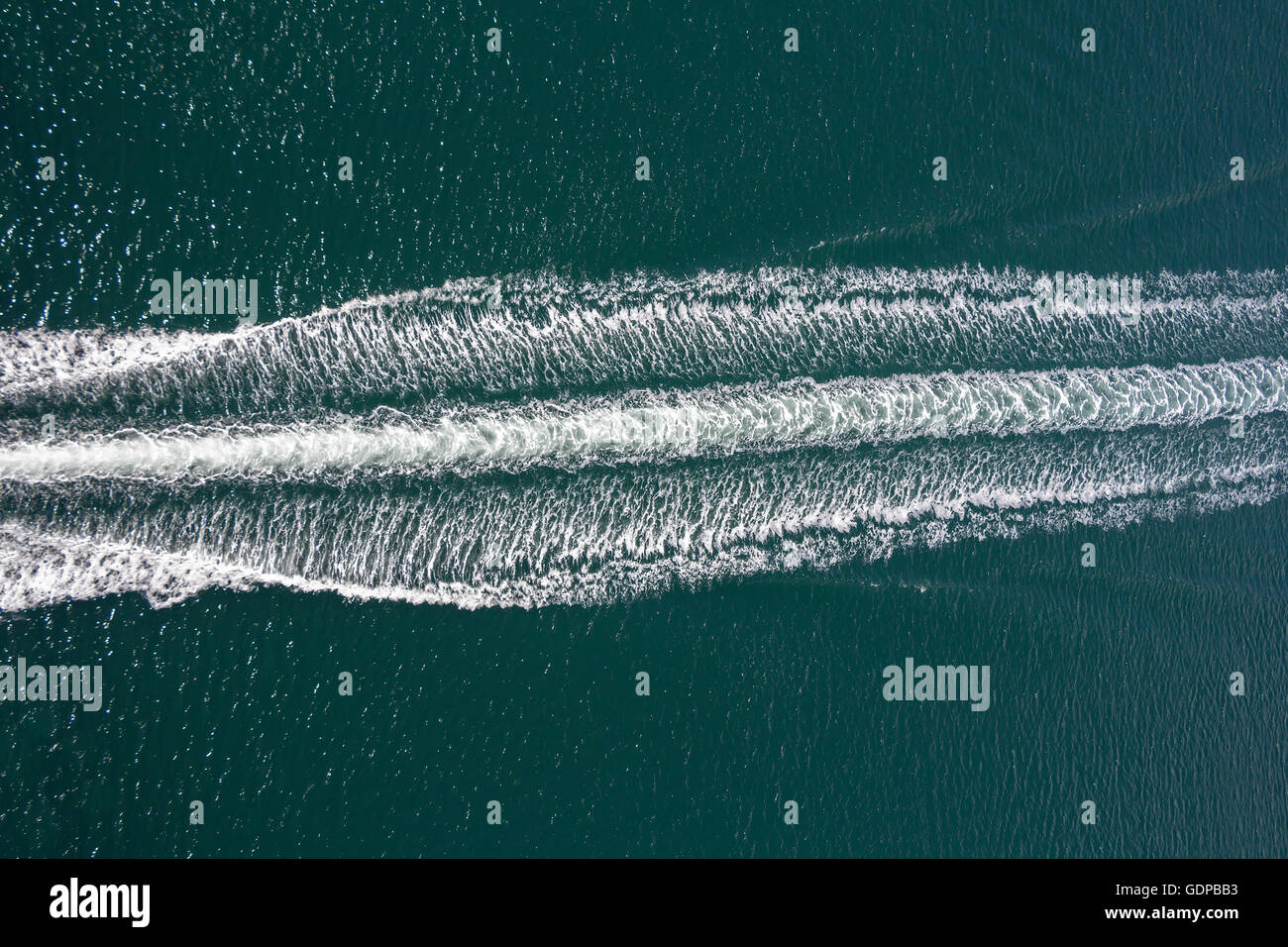 Waves trail behind cruising ship hi-res stock photography and images ...