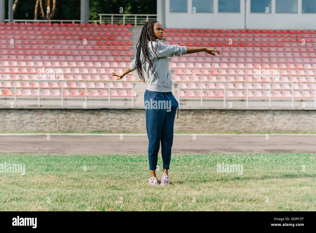Young attractive African American female working out outdoors at a ...