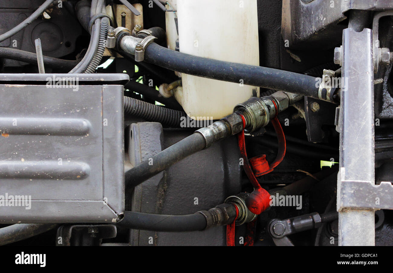 hoses, engine and spare parts inside the hood of the tractor Stock ...