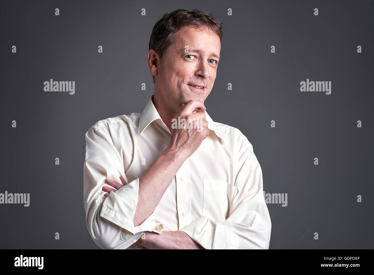 Middle age man smiling and laughing in the studio Stock Photo - Alamy