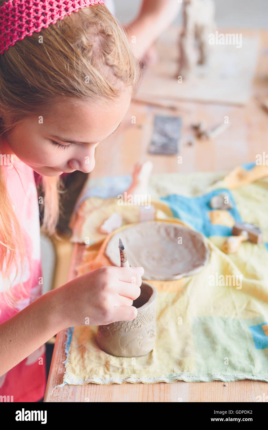 Girl making her first pottery in ceramic workshop Stock Photo - Alamy