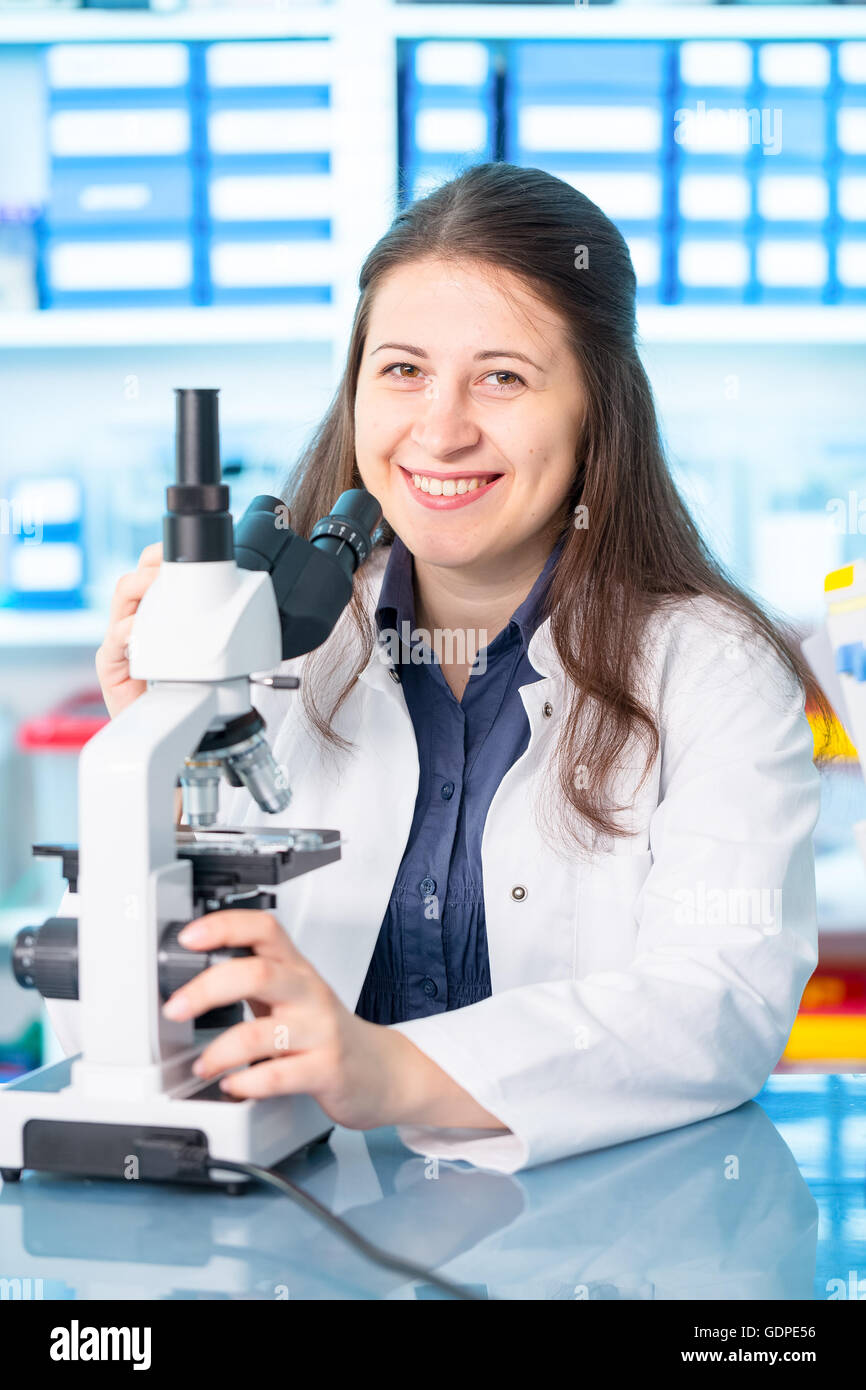 technician in the laboratory using a microscope Stock Photo - Alamy