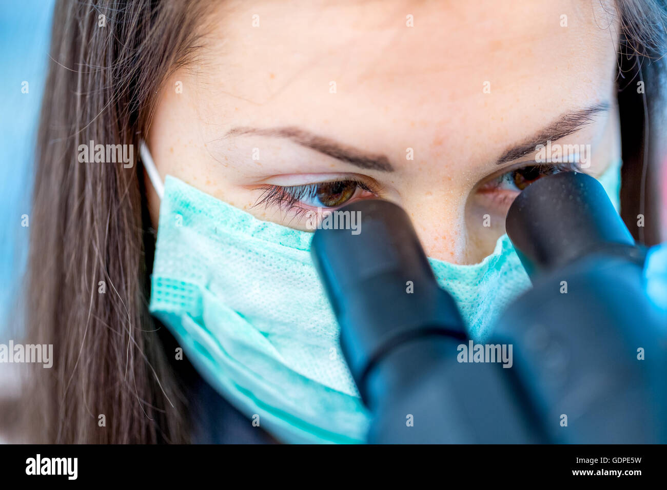 Doctor woman looking in microscope Stock Photo - Alamy
