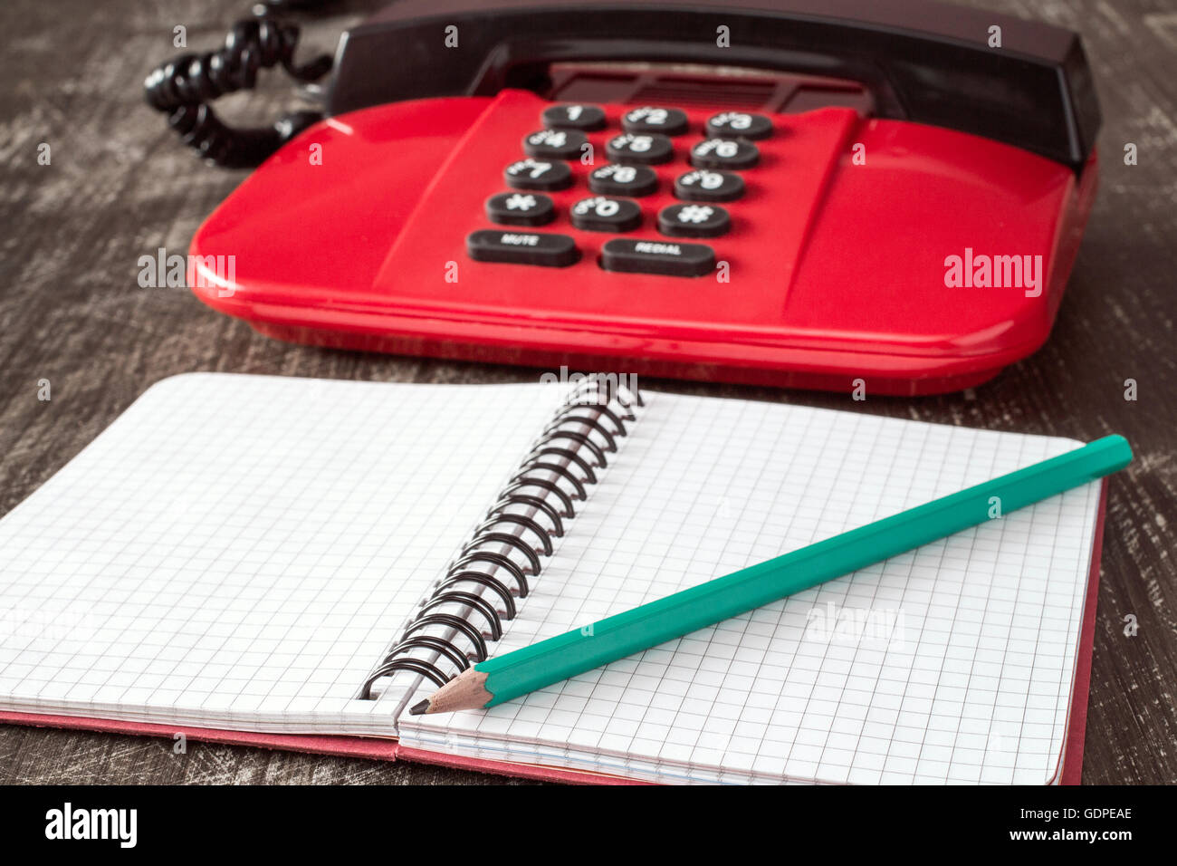 Old fashioned telephone and empty notebook with pencil Stock Photo - Alamy