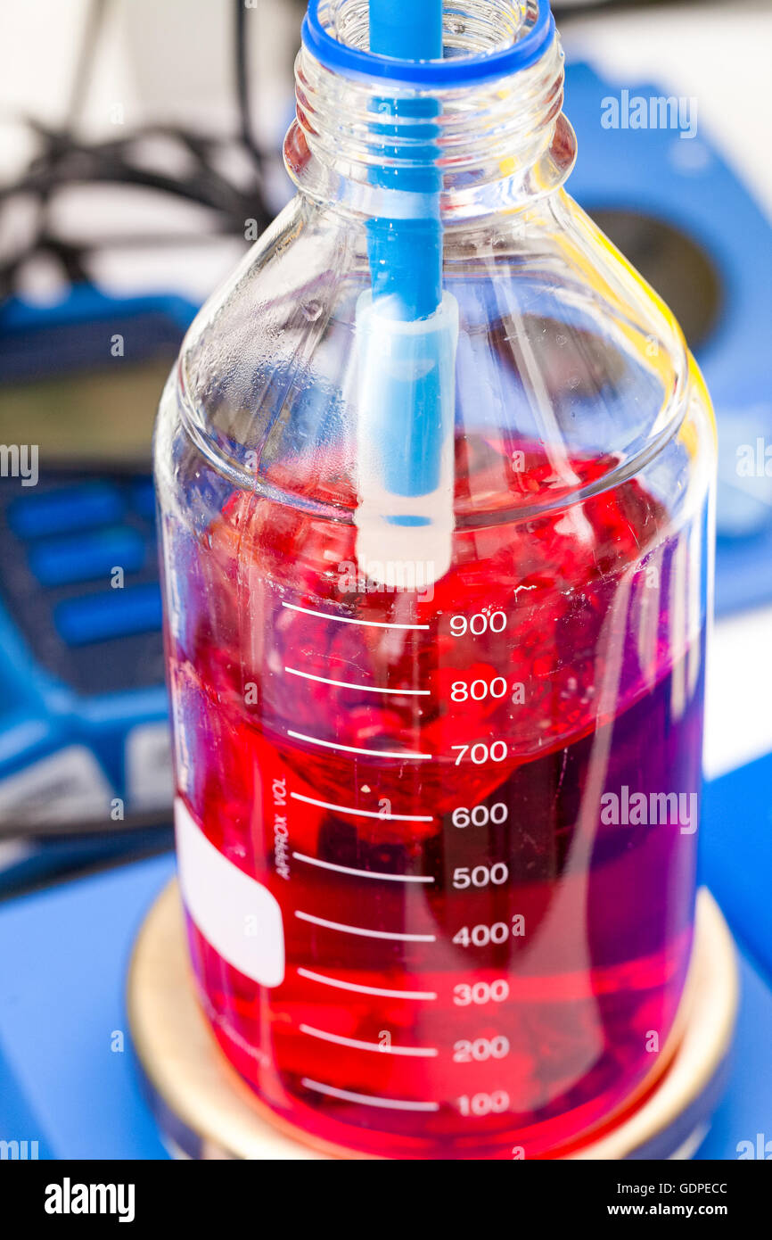 Bottle with red fluid in laboratory Stock Photo - Alamy