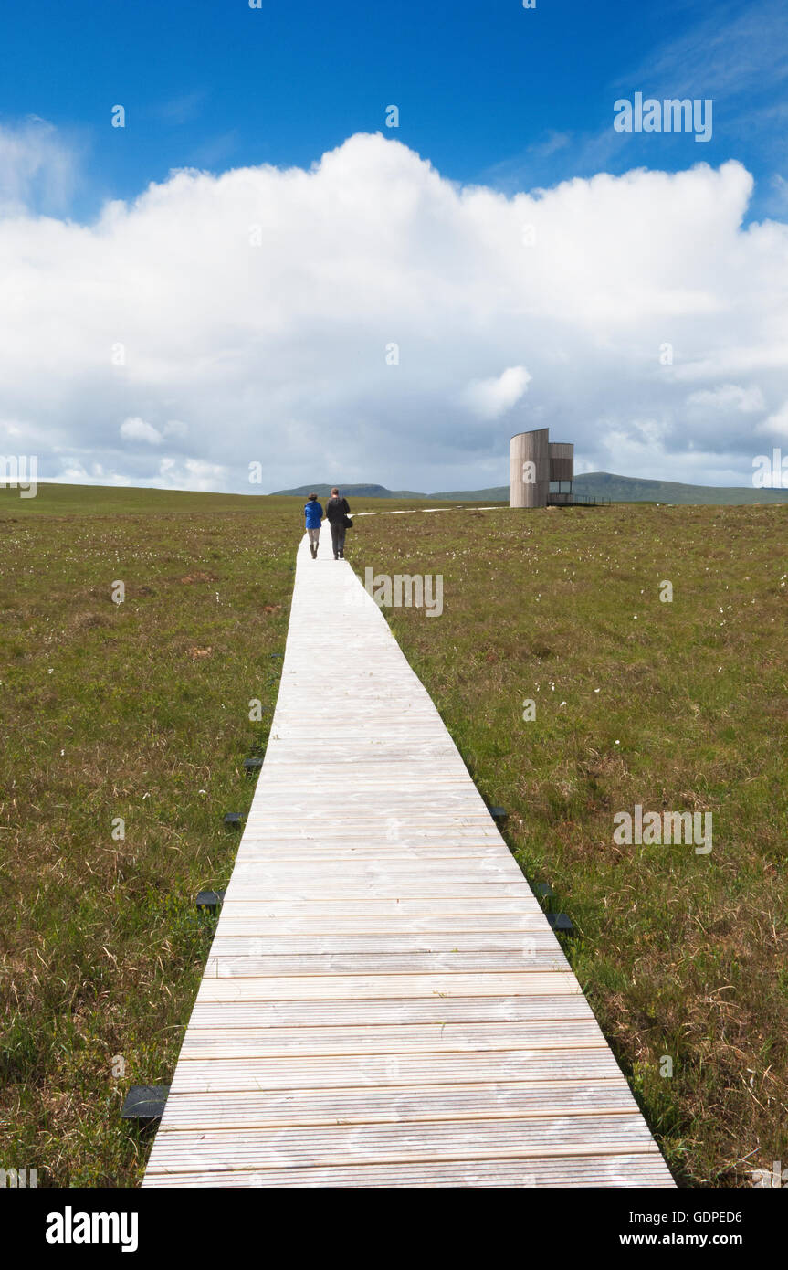 Visitors walking towards the viewing tower at Forsinard RSPB reserve ...