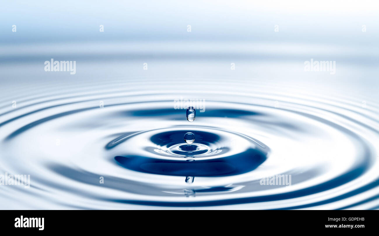 Drop of water falling on water level Stock Photo - Alamy