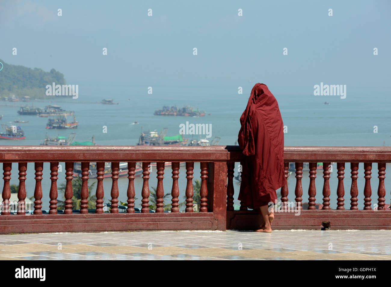 a monk at the Temple Theindawgyi shrine over the city of Myeik in the ...