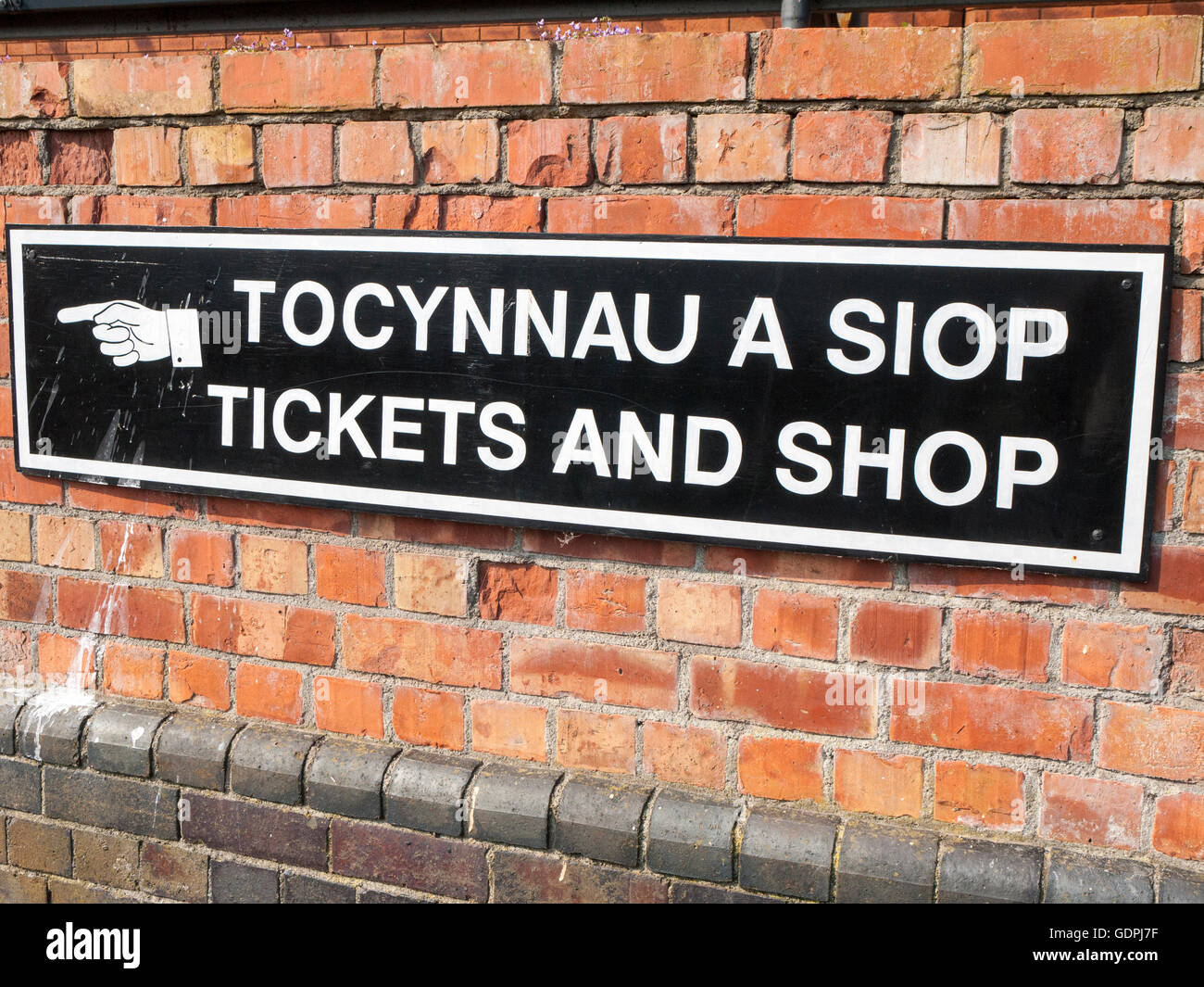 Hand sign pointing to tickets and shop sign in English and Wales ...