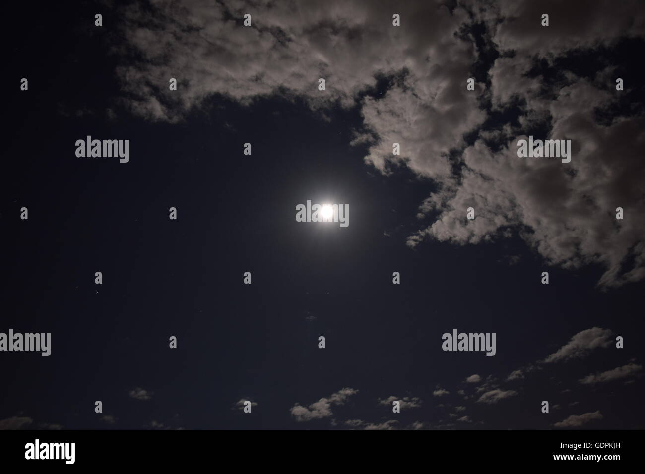 full moon in cloudy sky Stock Photo - Alamy