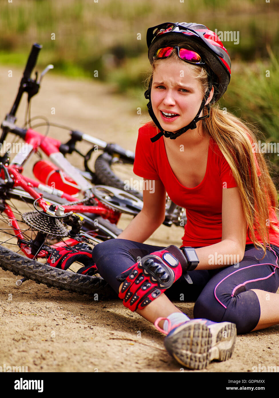 Bikes cycling girl wearing helmet fell off bike Stock Photo - Alamy